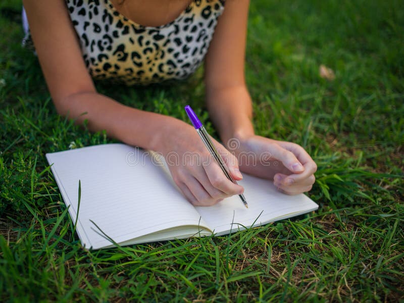 Happy Teen Writing On Grass Stock Photo - Image of happy, teenager ...