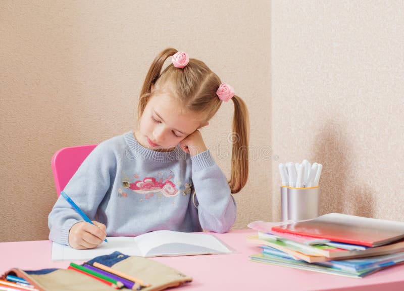 Girl writing at the table stock image. Image of pupil - 84095439