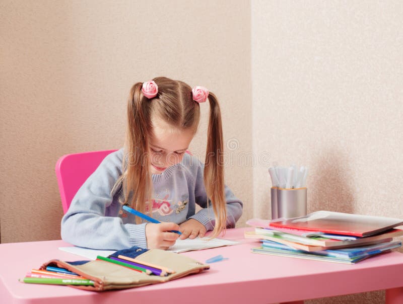 Girl writing at the table stock image. Image of female - 84096295