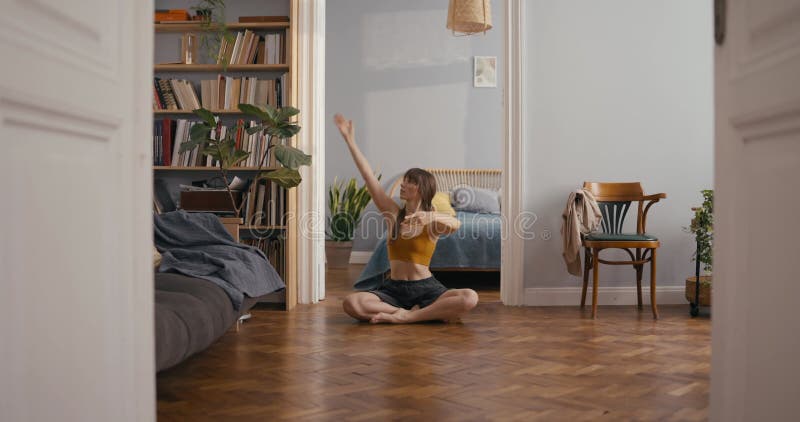 Girl in Yellow Top Sits on Floor and Creates Classical Dance Elements ...