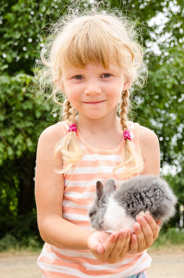 Girl with Young Bunny Rabbit Stock Image - Image of happy, animal: 57112849