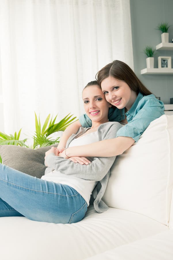 Girlfriends Hugging on Sofa Stock Image - Image of friendship, holding ...