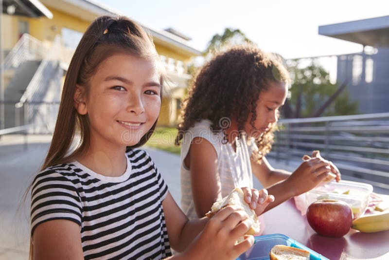 Girlfriends at School Lunch Table, One Smiling To Camera Stock Image ...