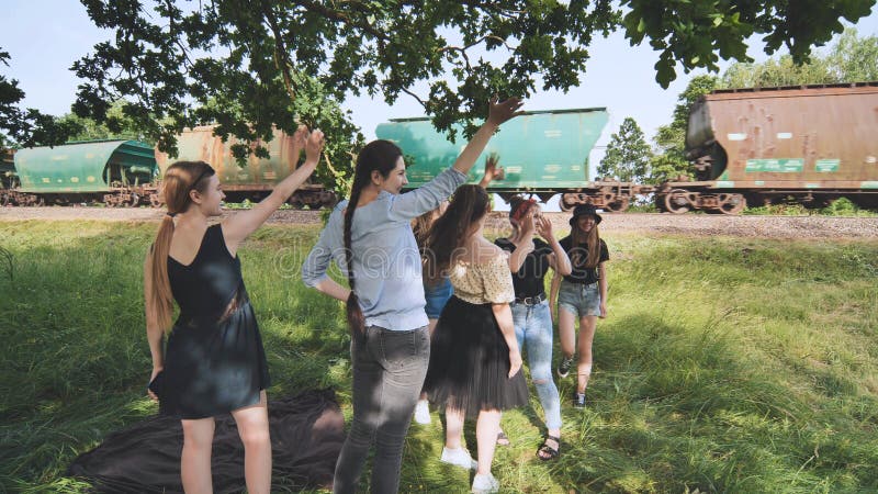 Girlfriends Waving Their Hands To a Passing Train. Stock Photo - Image ...