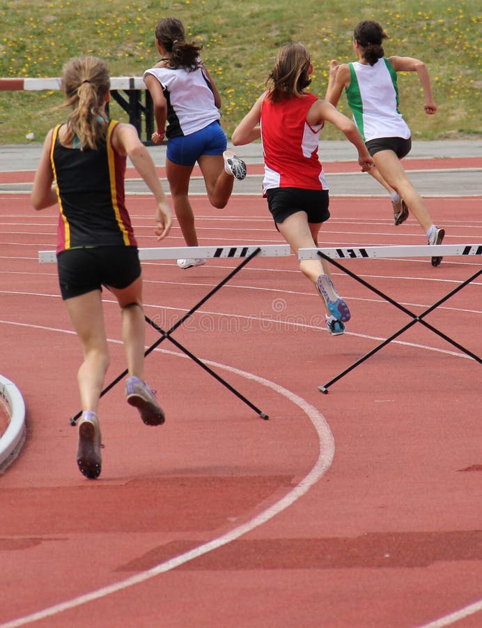 Girls on the hurdles race editorial stock image. Image of competitor ...