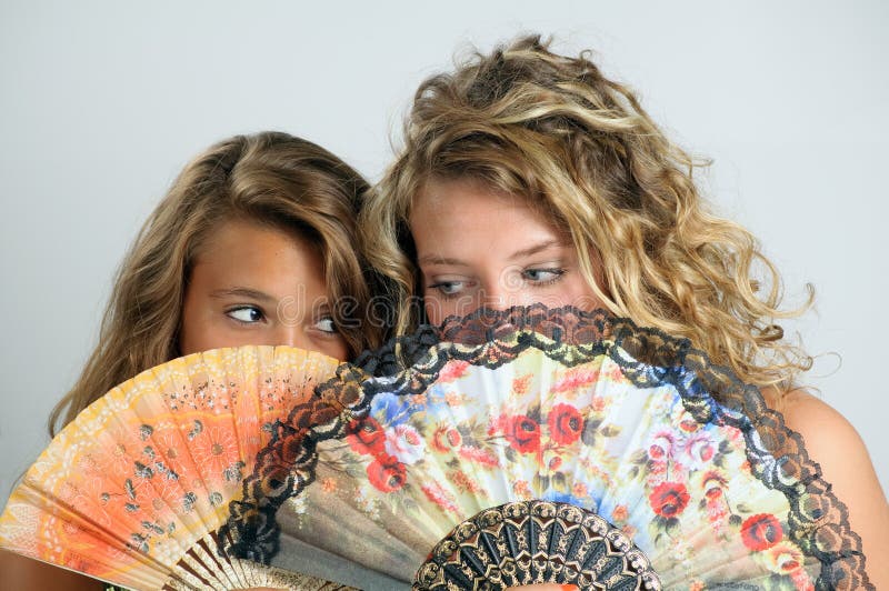 Girls behind fans stock photo. Image of teen, girl, pretty - 21938438
