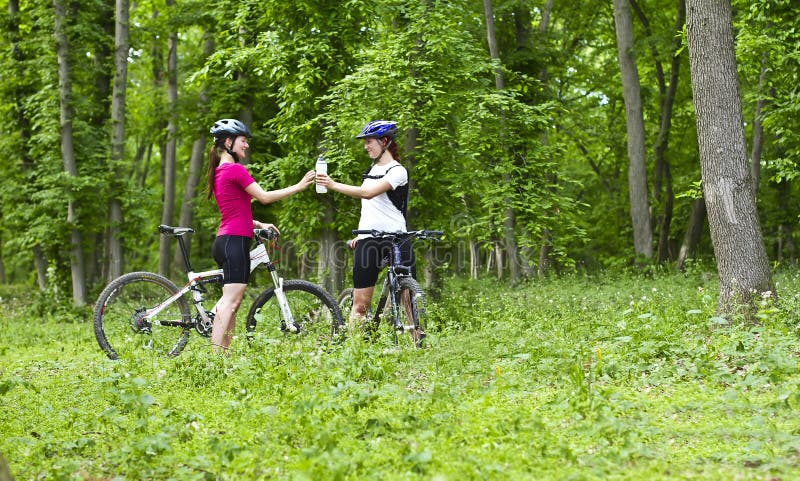 Girls biking in the forest stock image. Image of leisure - 31882703