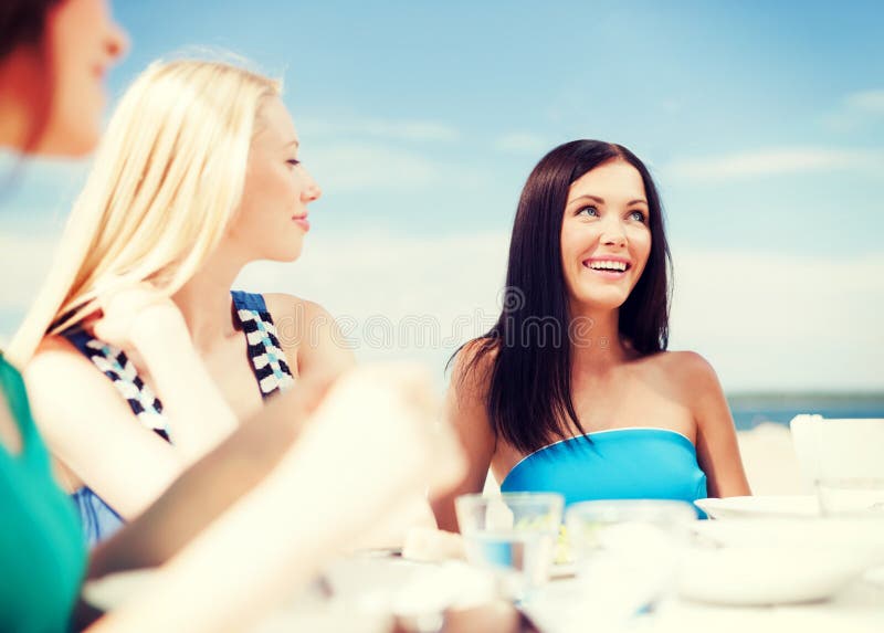 Girls in cafe on the beach stock image. Image of lunch - 41032425