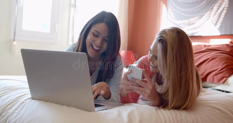 Girls Chatting on Laptop while Lying on Bed Stock Video - Video of ...