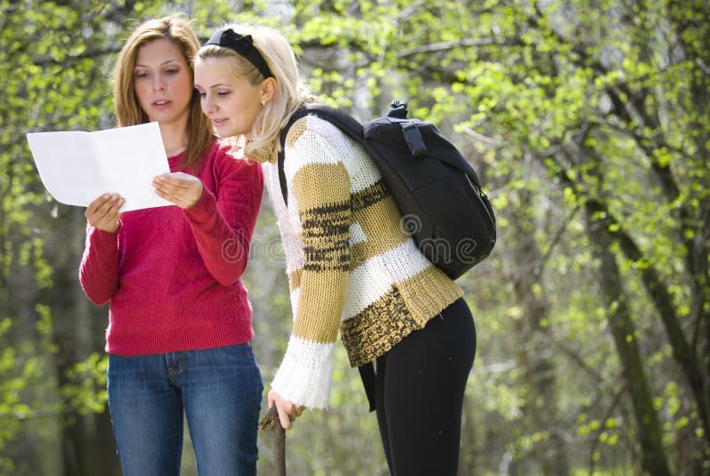 Girls checking a map stock photo. Image of positioning - 2487542
