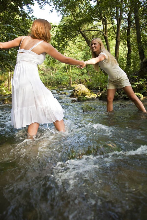 Girls Crossing the Stream stock image. Image of flow - 10446497