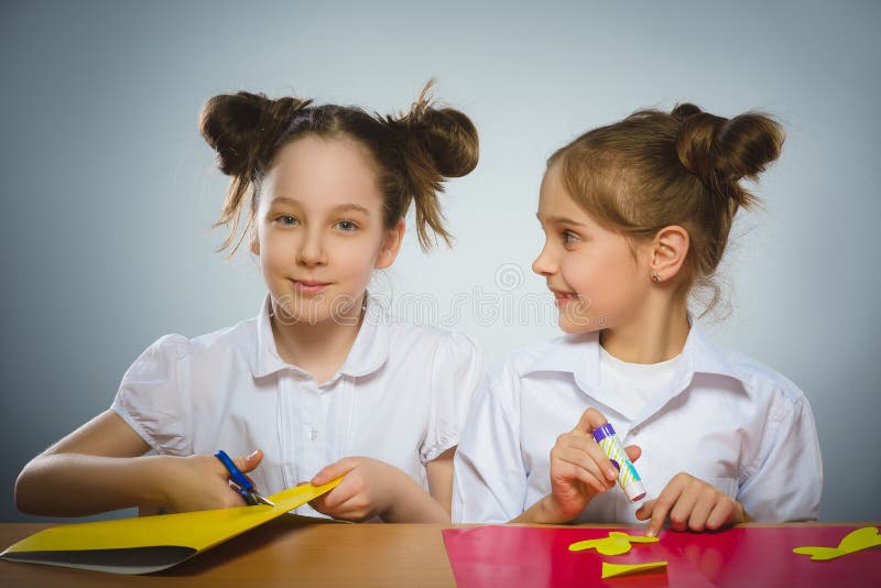 Girls Do Something from Colored Paper Using Glue and Scissors Stock ...
