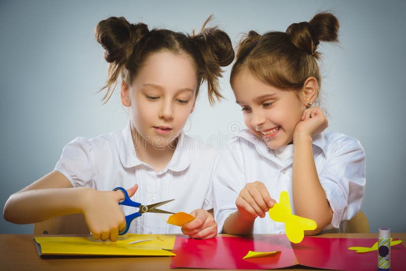Girls Do Something from Colored Paper Using Glue and Scissors Stock ...