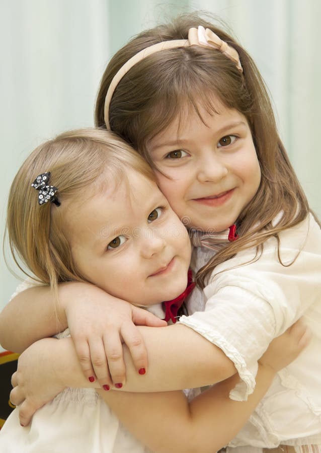 Girls embrace stock image. Image of children, sisters - 24331389