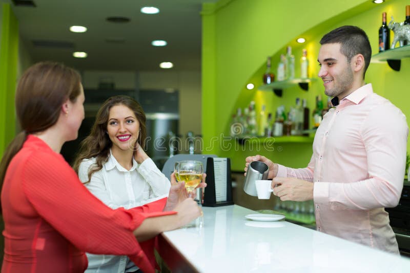 Girls flirting with barman stock photo. Image of barman - 48070122