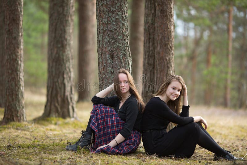 Girls Girlfriends Sitting Together in a Pine Forest. Nature. Stock ...