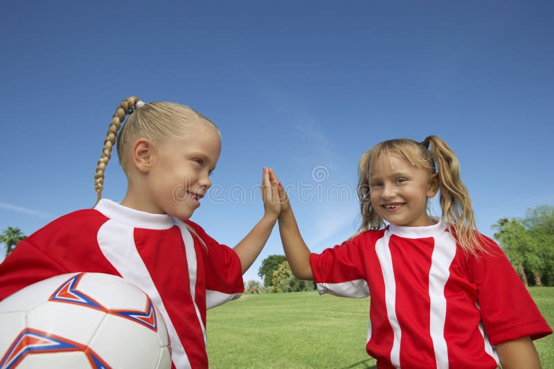 Girls Giving a High-Five on Soccer Field Stock Photo - Image of ...