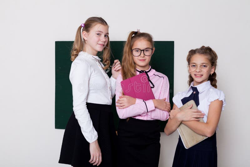 Three Girls in Glasses at the Blackboard in a Class Lesson Stock Image ...