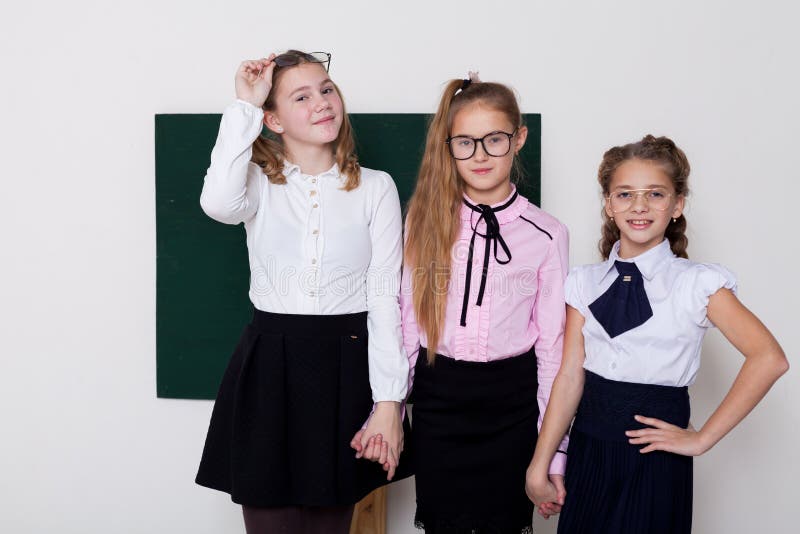 Three Girls in Glasses at the Blackboard in a Class Lesson Stock Image ...