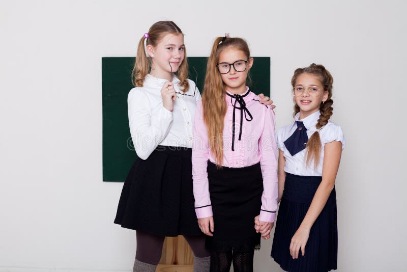 Three Girls in Glasses at the Blackboard in a Class Lesson Stock Photo ...