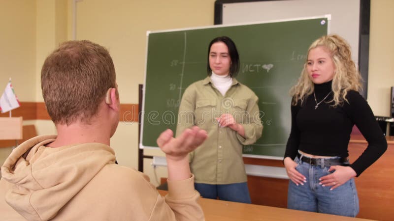 The Girls and the Guy are Talking in Russian Sign Language. Three Deaf ...
