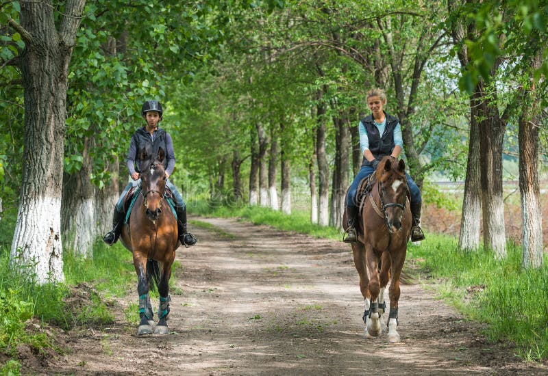 Girls on horseback riding stock photo. Image of stirrups - 40310102
