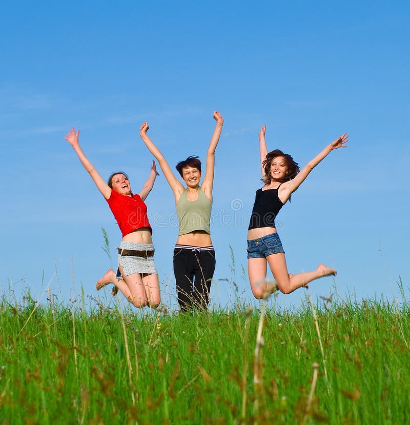 Girls jump on the meadow stock image. Image of natural - 9920407