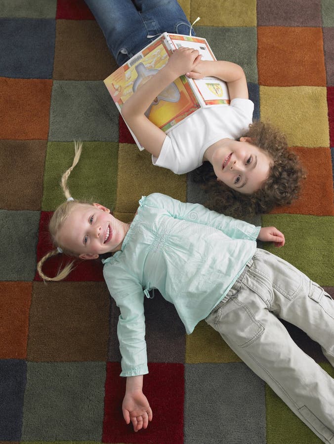 Girls Lying Down on Mat stock photo. Image of book, indoors - 29656498