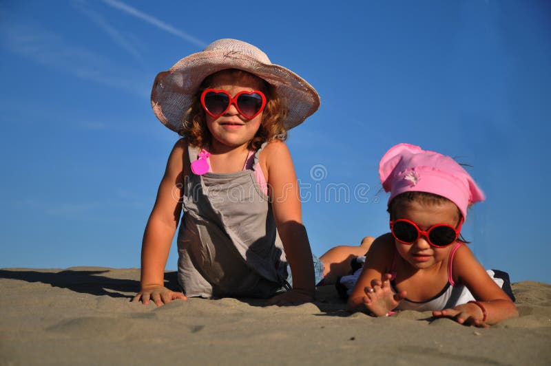 Girls Lying on the Sandy Beach Stock Photo - Image of summer, sand ...