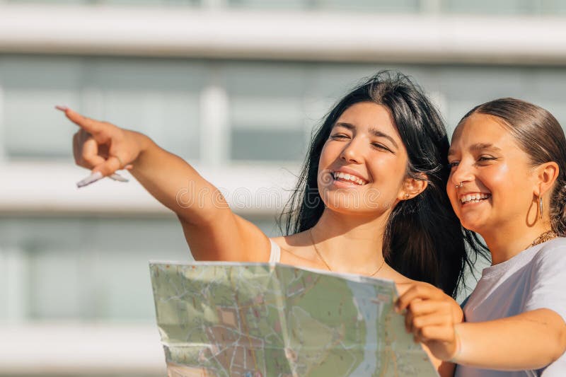 Girls with map on street stock image. Image of direction - 319160779