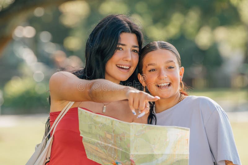 Girls with map on travel stock photo. Image of direction - 330520670