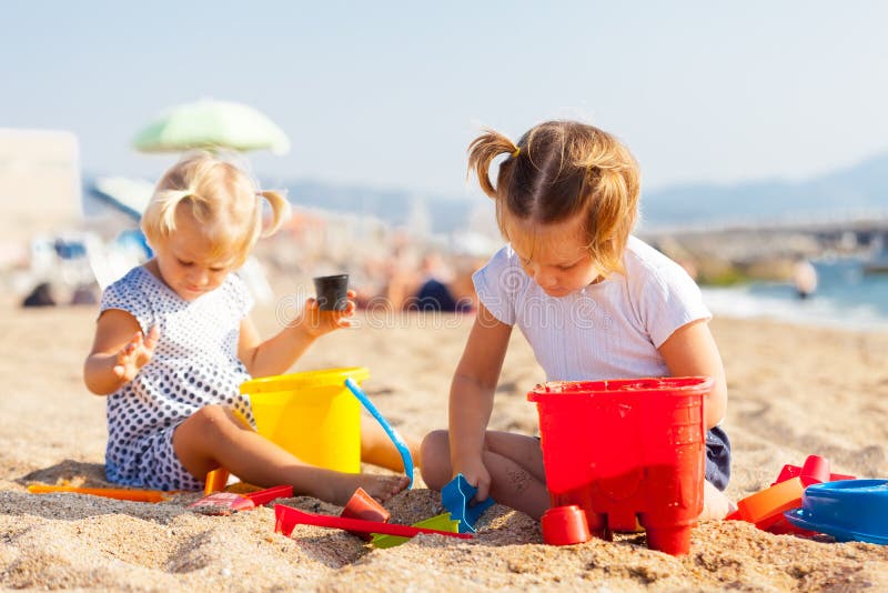 Girls playing on beach stock image. Image of childhood - 46794661