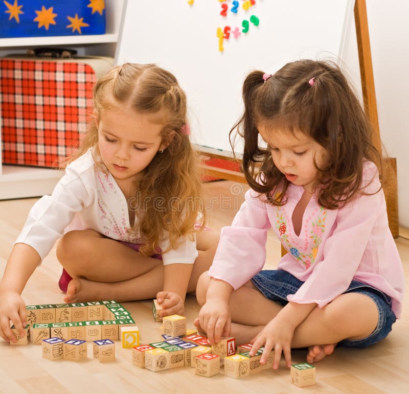 Girls playing with blocks stock image. Image of color - 13947445