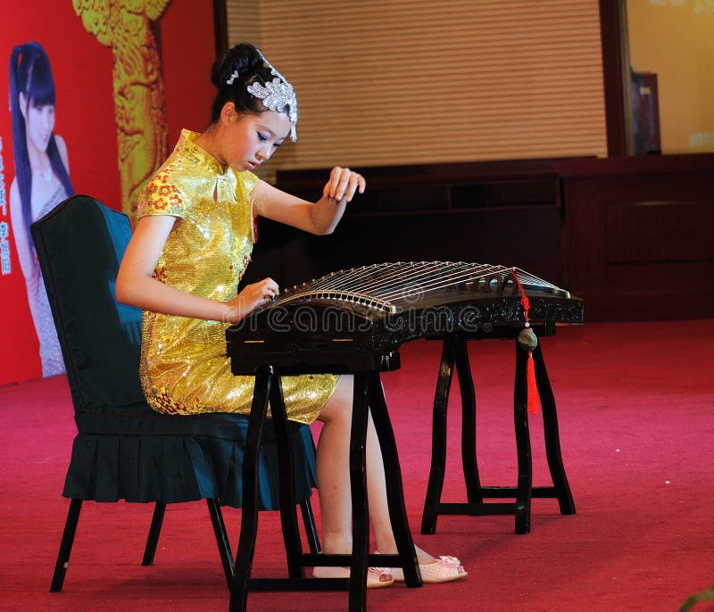 Girls play the Guzheng editorial stock image. Image of playing - 25321489