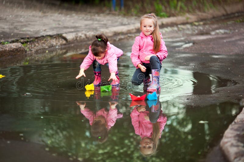 Cute Little Girl Jumping into a Puddle Stock Image - Image of rubber ...
