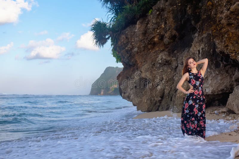 Girls Posing on the Beach in Front of the Rock. Stock Photo - Image of ...