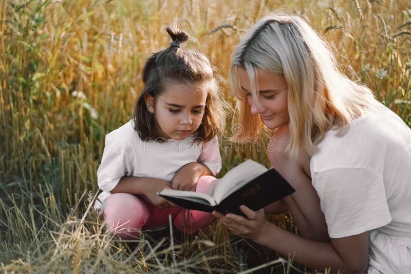 Girls Reading Holy Bible in a Wheat Field. Study the Holy Bible ...