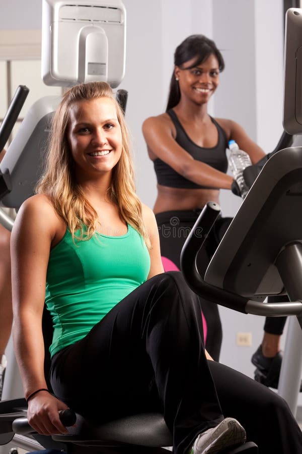 Women on Exercise Bikes stock photo. Image of bike, lifestyle - 2693532