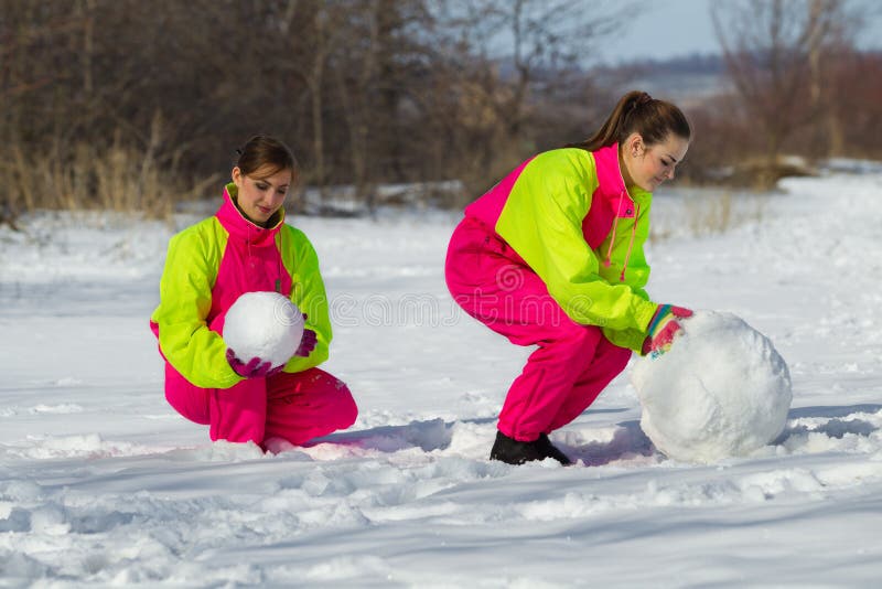 Girls Rolling a Huge Snowbal Stock Image - Image of snow, cold: 26636361
