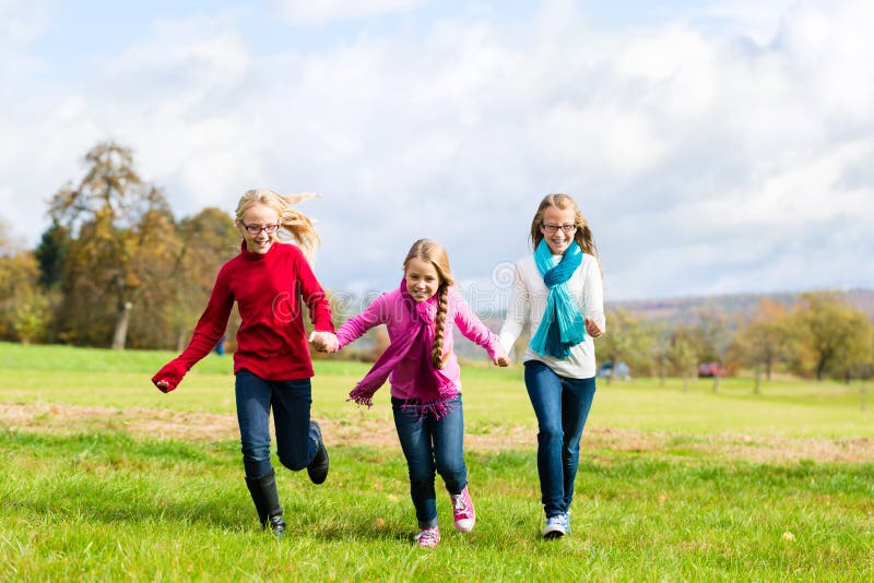 Girls Running through Fall or Autumn Park Stock Photo - Image of ...