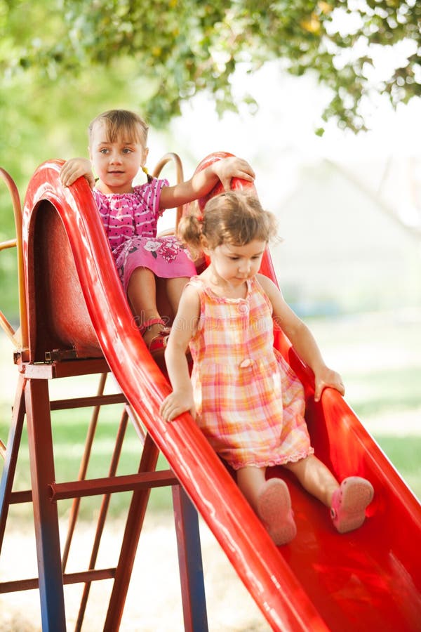Girls on the slide stock image. Image of playing, toddler - 43722561