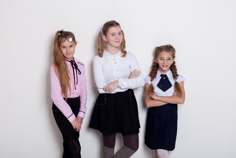 Schoolgirl Girls Stand at a White Wall in Class Stock Photo - Image of ...