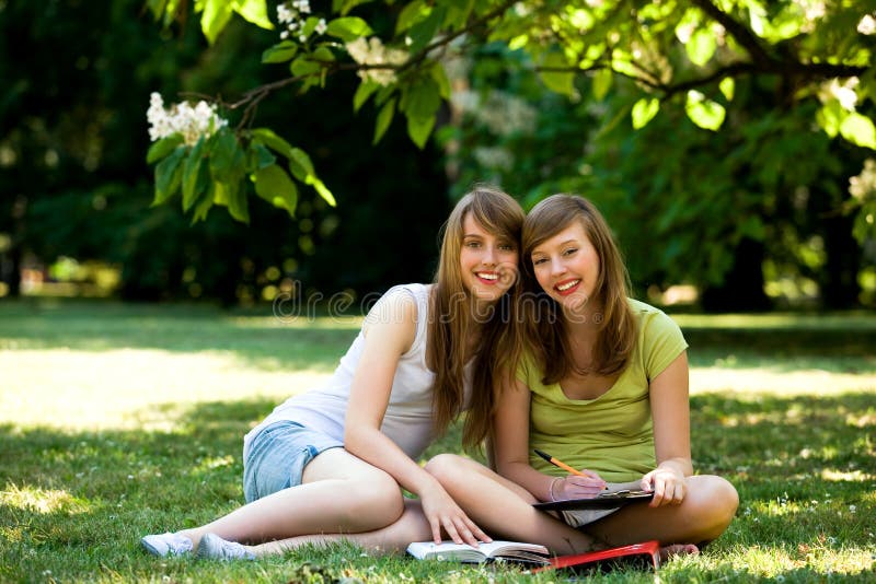 Girls studying outdoors stock photo. Image of classmate - 15624850