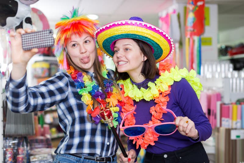 Girls Taking Selfie In Store Of Festival Accessories Stock Image