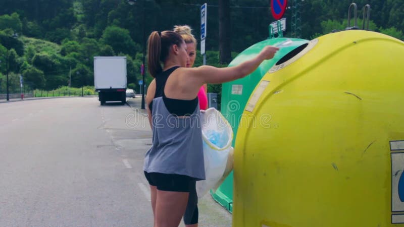 Girls Throwing Garbage To Recycling Dumpster Stock Video - Video of ...