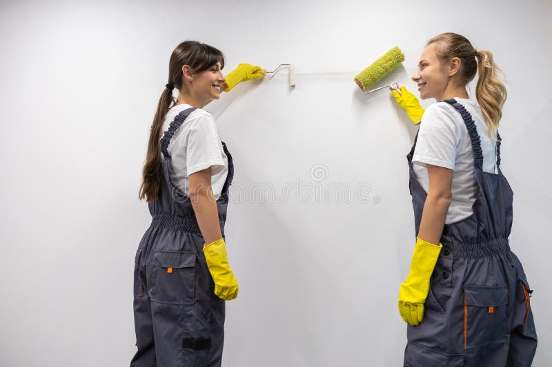 Girls in Uniform Painting the Wall and Enjoying the Process Stock Photo ...