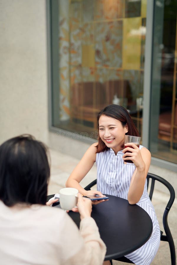 Girls Use Their Break from Work To Drink Coffee and Chat Stock Photo ...