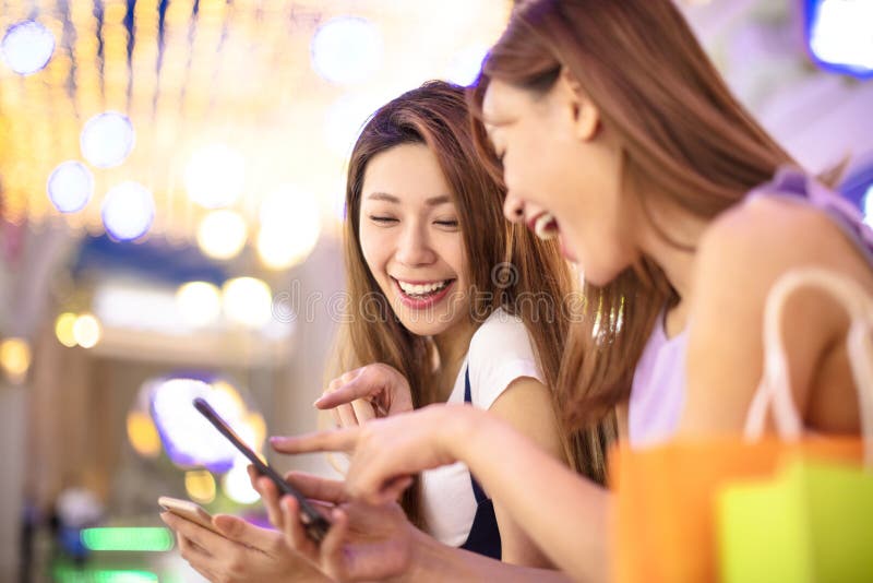 Girls Using Smart Phone in the Shopping Mall Stock Photo - Image of ...