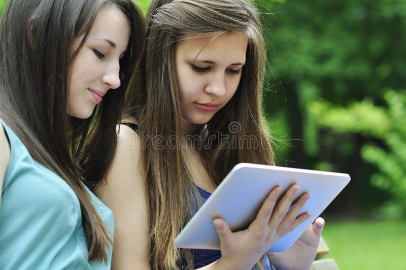 Girls using a tablet pc stock image. Image of modern - 25272153