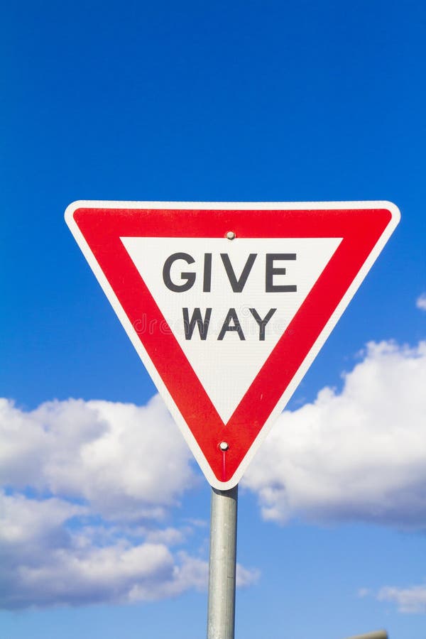 Give Way Sign Against a Blue Sky Stock Image - Image of careful, brake ...